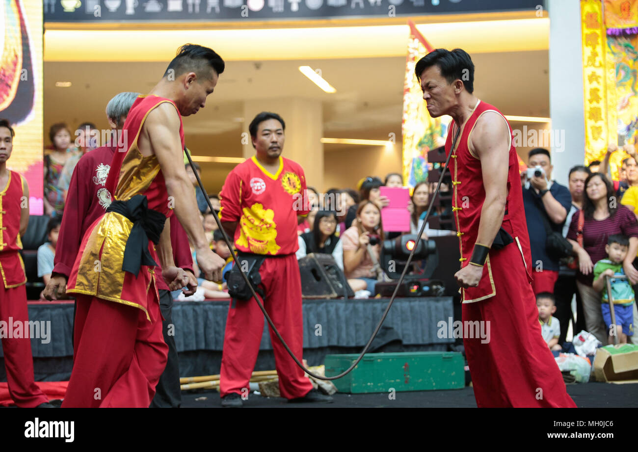 Chinese traditional stuntmans bending steel rod with their throats at ...