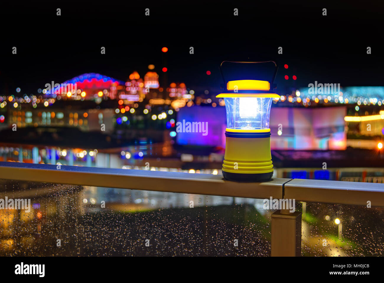 Luminous hand lantern standing on the fence of balcony on the ...