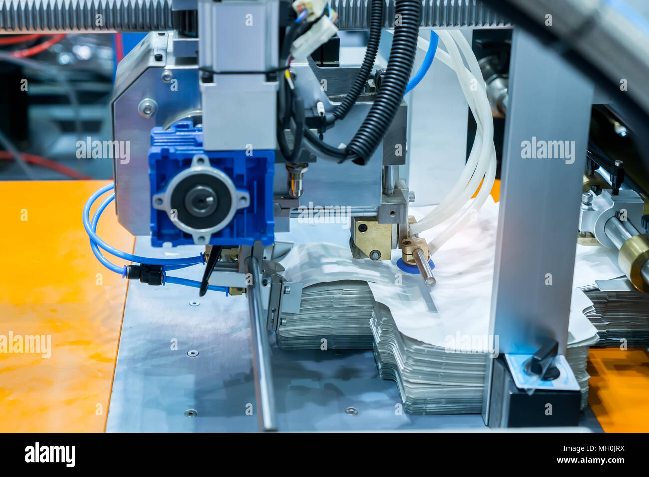 machines of a large printing plan with robot with vacuum suckers picks ...