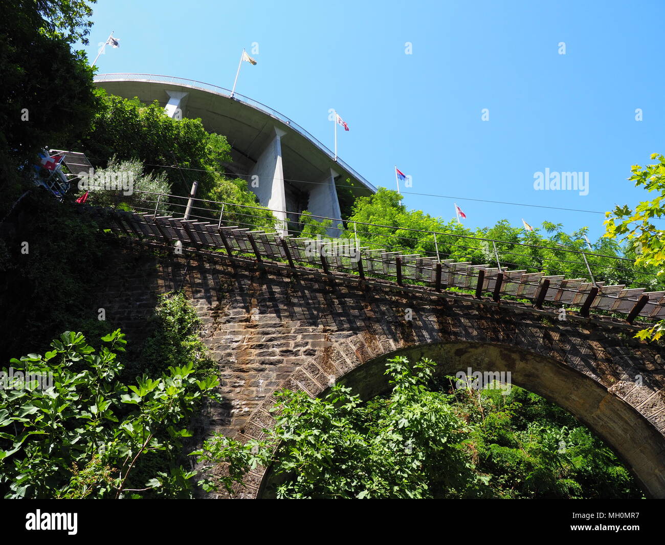 Funicular railway on stony bridge in european Locarno city on lake ...