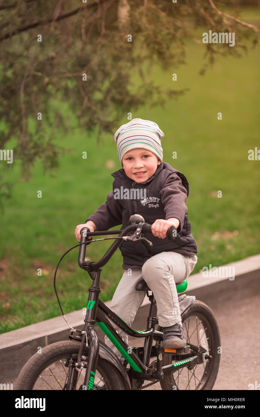 Happy four years old boy learning how to ride a bike. First riding ...