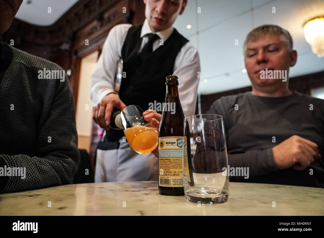 A waiter pours a beer in Cafe Sabarsky in the Galerie Neue in New York ...