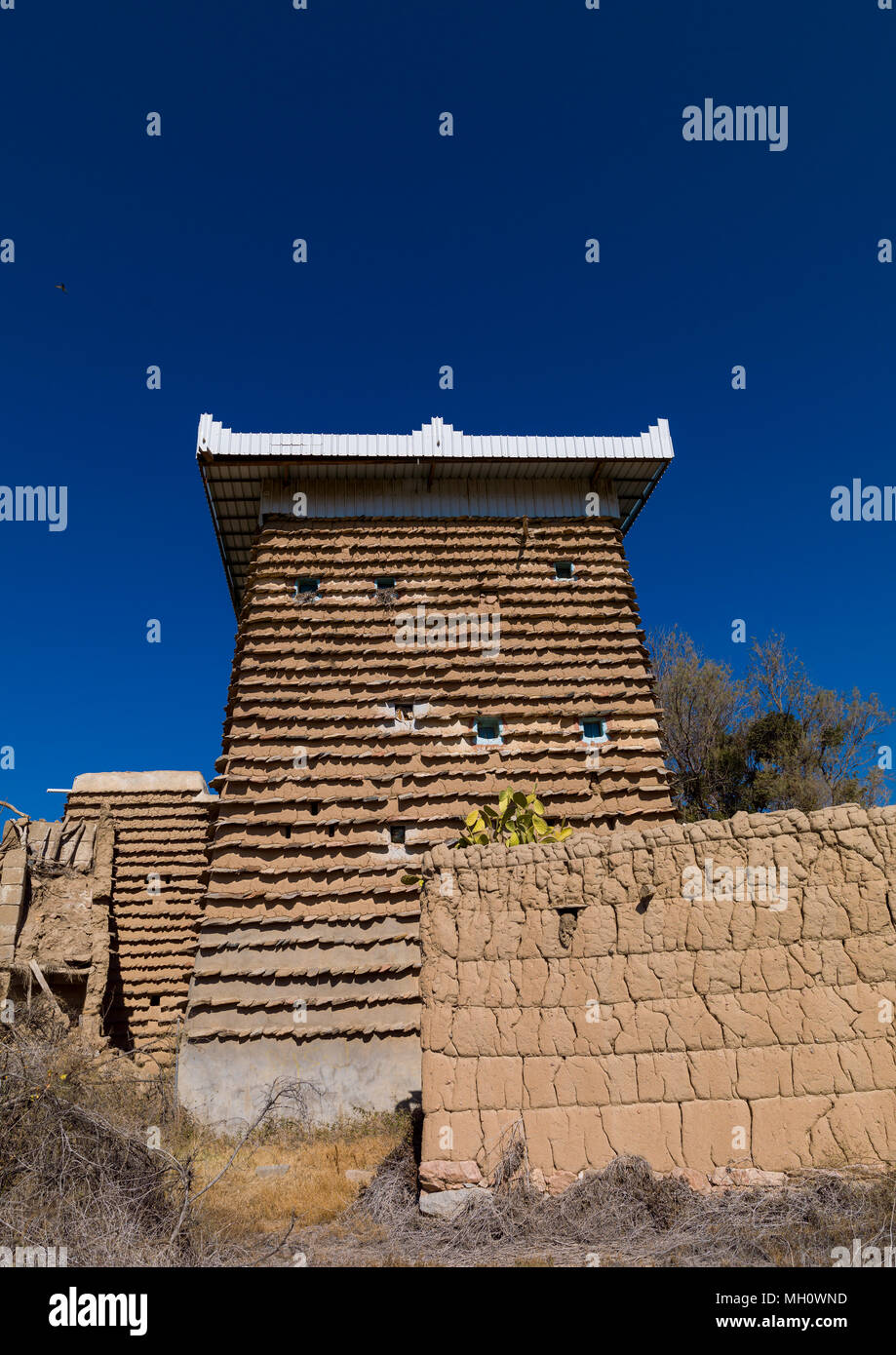 Traditional clay and silt home with a modern roof in a village, Asir ...
