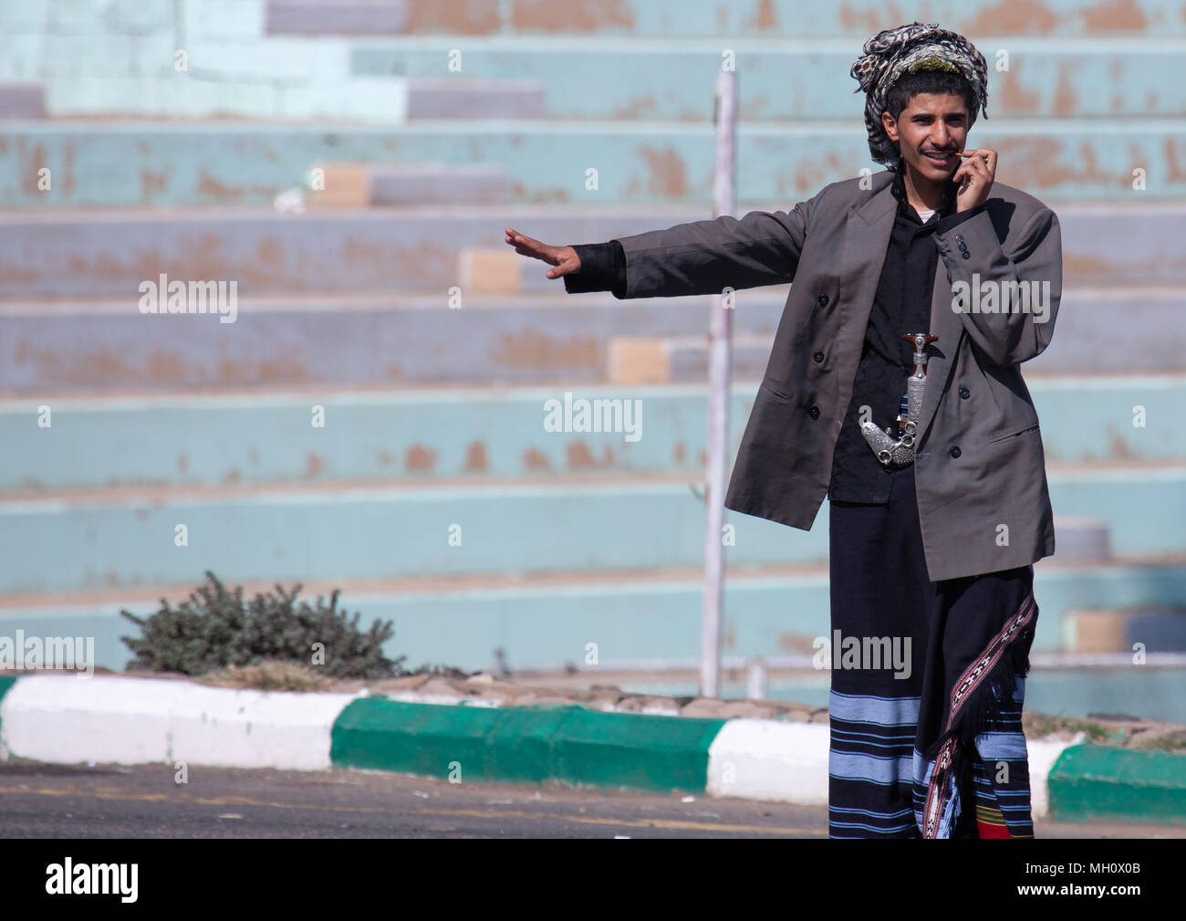 Saudi flower man hitchhiking at roadside , Asir province, Sarat Abidah ...