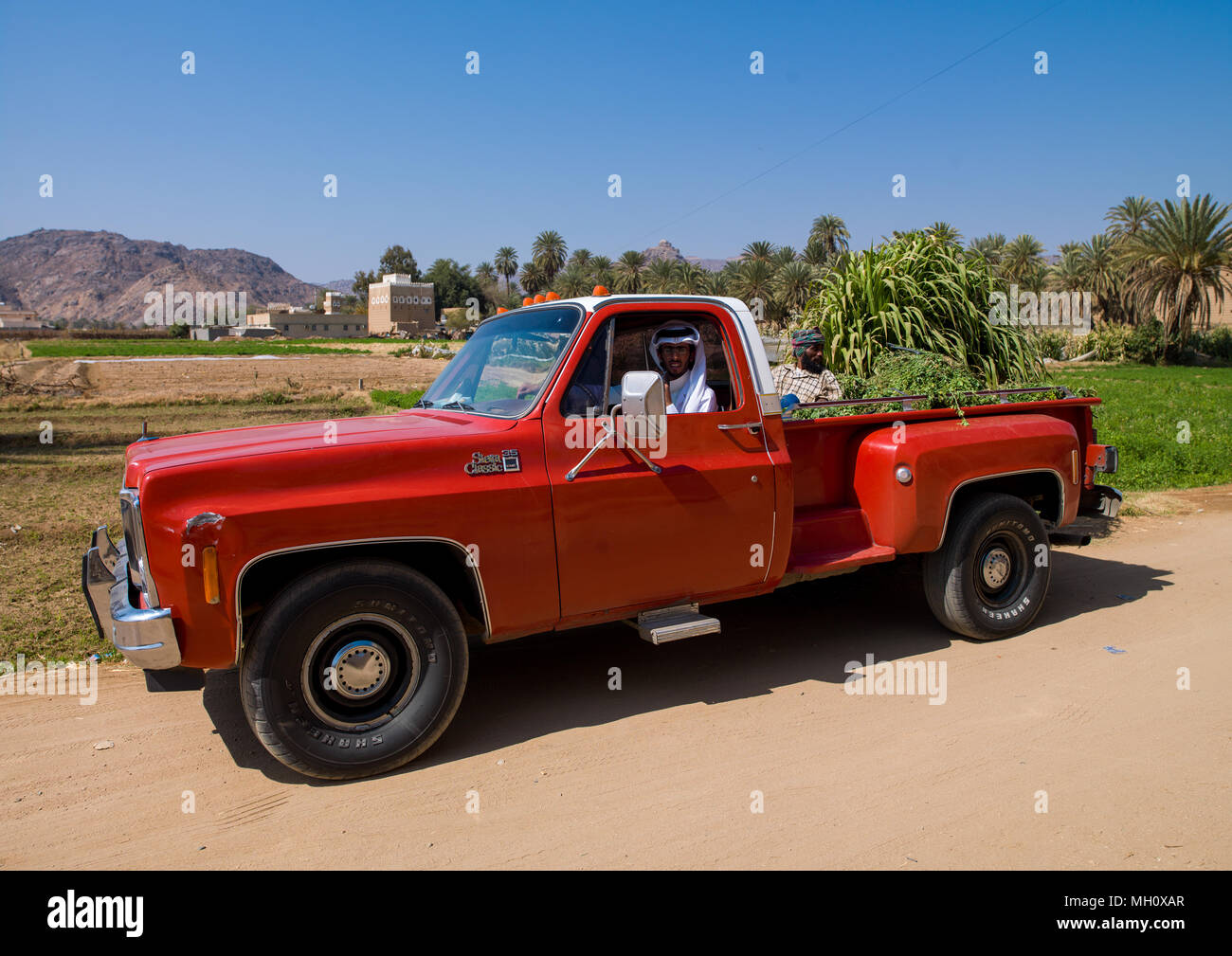 Saudi farmer in a red car near his field, Najran Province, Najran ...
