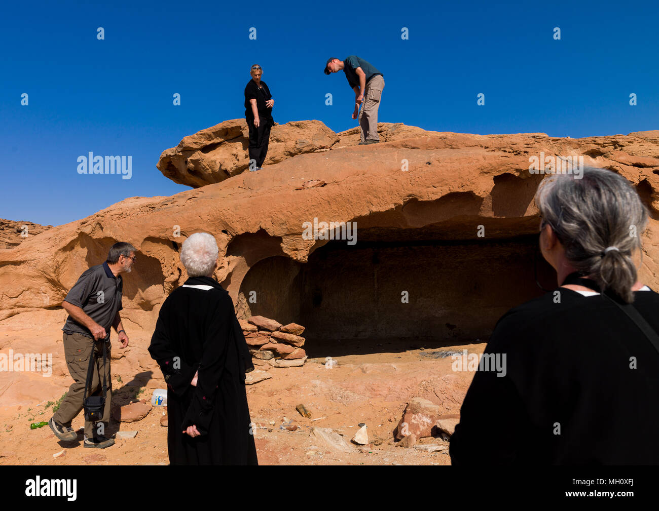 Western tourists visiting a qadeer sand stone castle, Al-Jawf Province ...