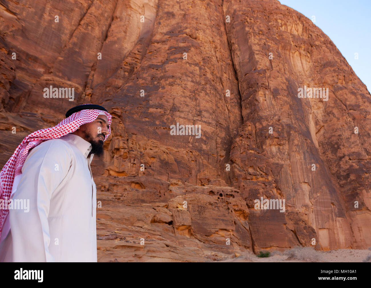 Saudi man in front of a hill in madain saleh archaeologic site, Al ...
