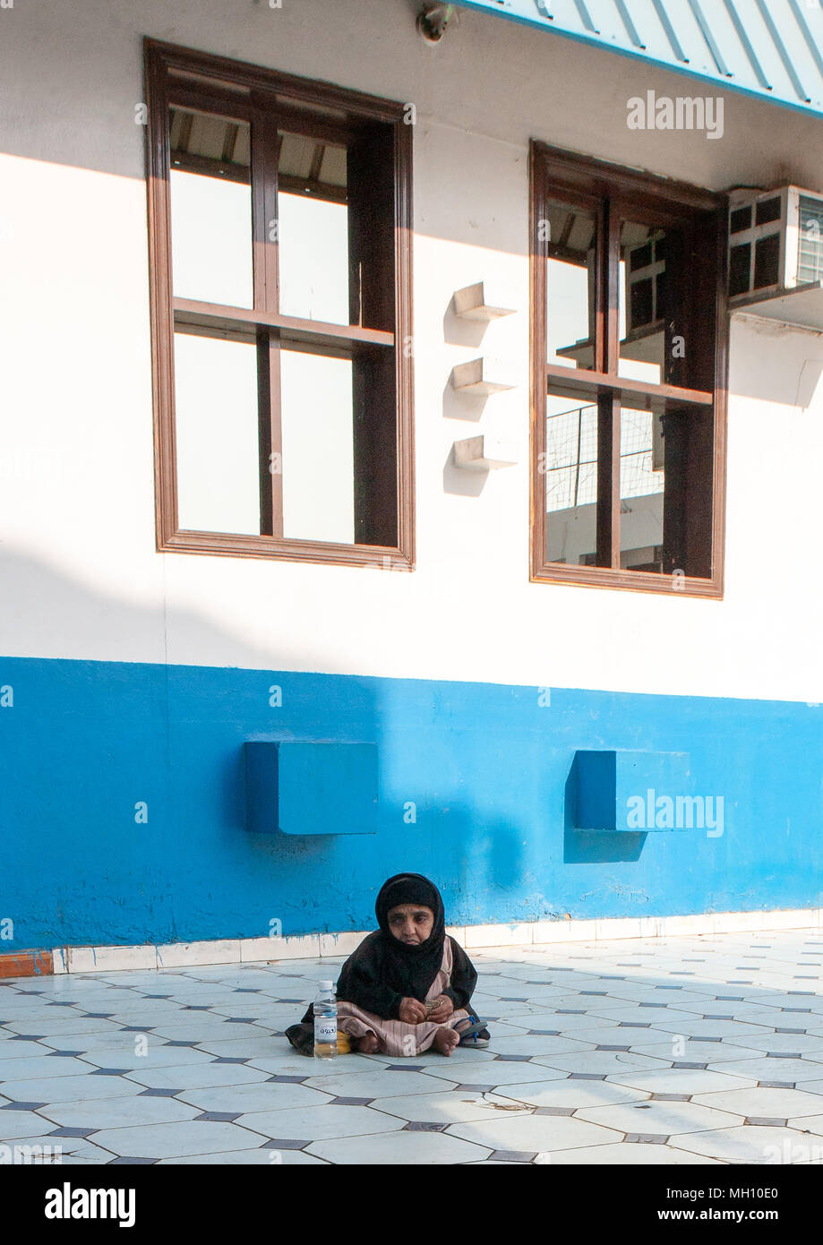 Handicapped woman begging for money near a mosque, Hijaz Tihamah region ...