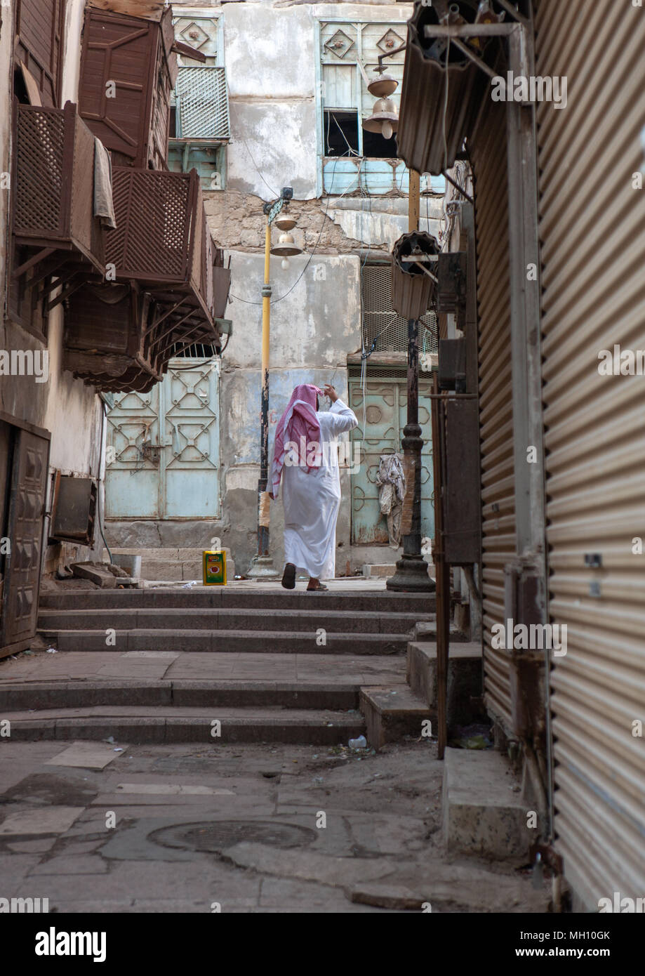Saudi man walking in a street in the old quarter, Hijaz Tihamah region ...