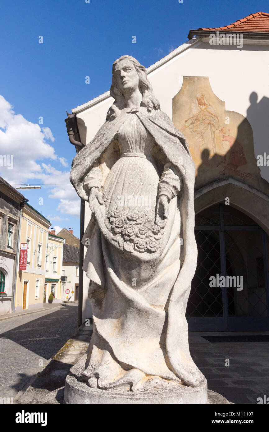 The statue and the fresco showing alms being distributed are symbolic ...