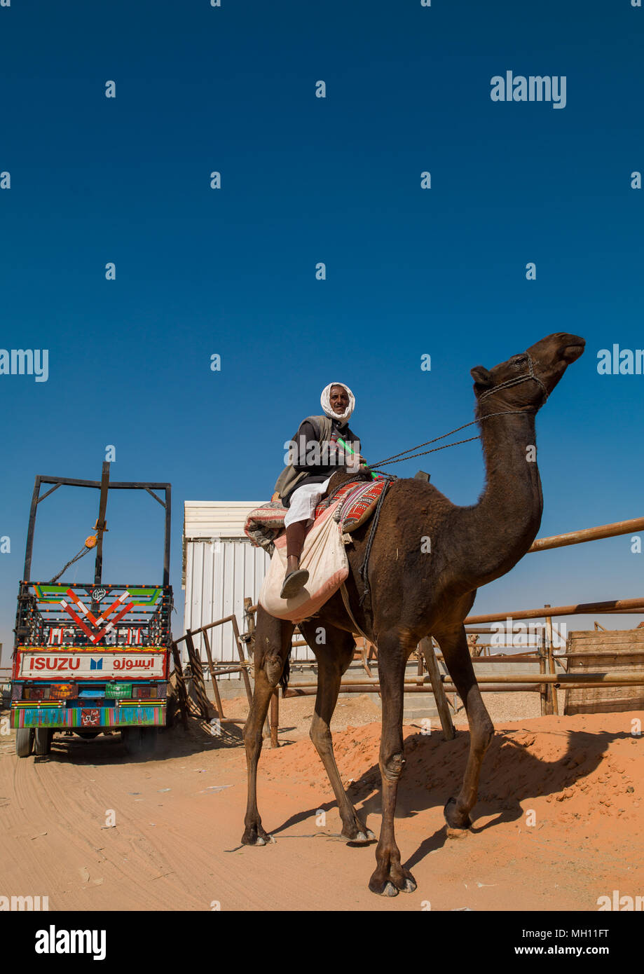 Rashaida sudanese man riding a camel in the market, Riyadh Province ...