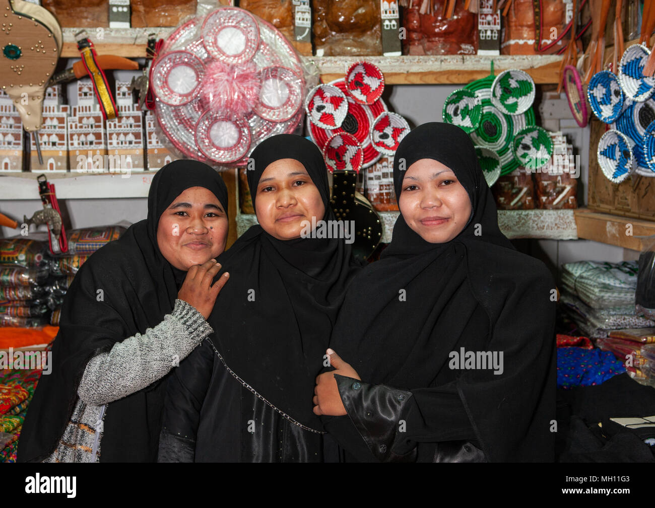 Indonesian muslim foreign women in the souk working as sellers in a ...