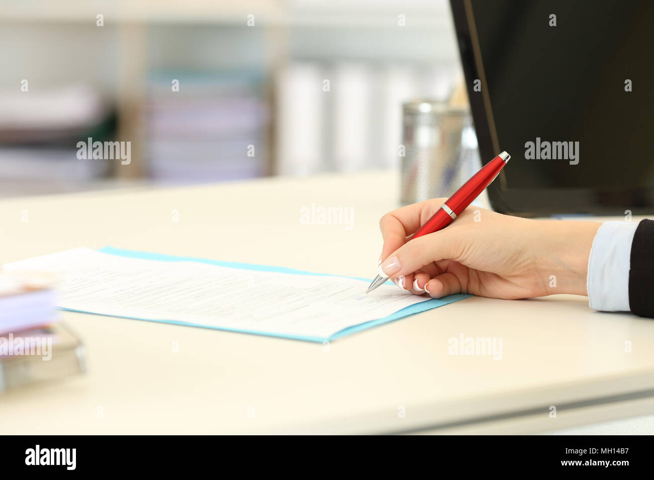 Close up portrait of an executive hand signing a form or contract on a ...