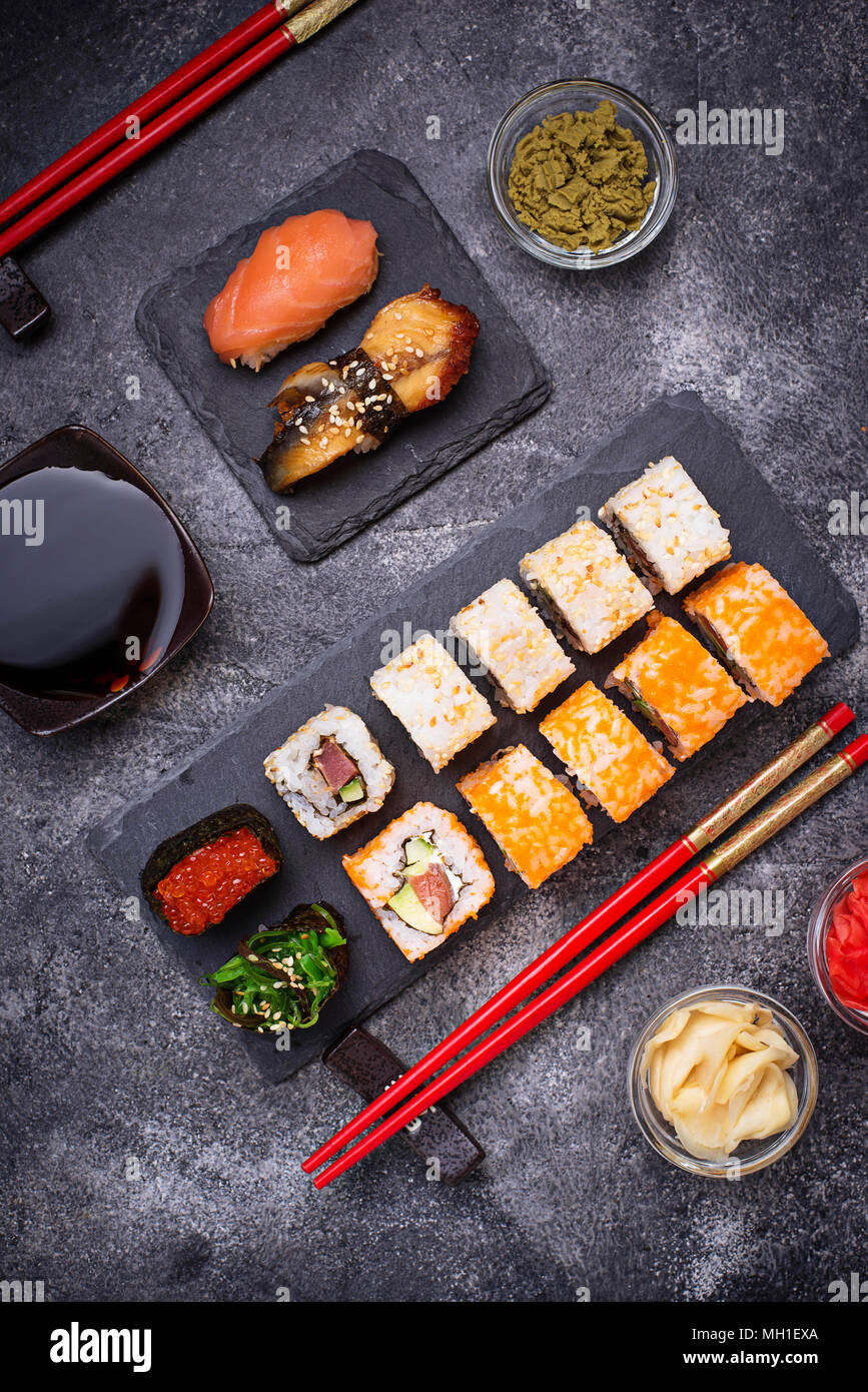 Sushi and roll set on black table. Top view Stock Photo - Alamy