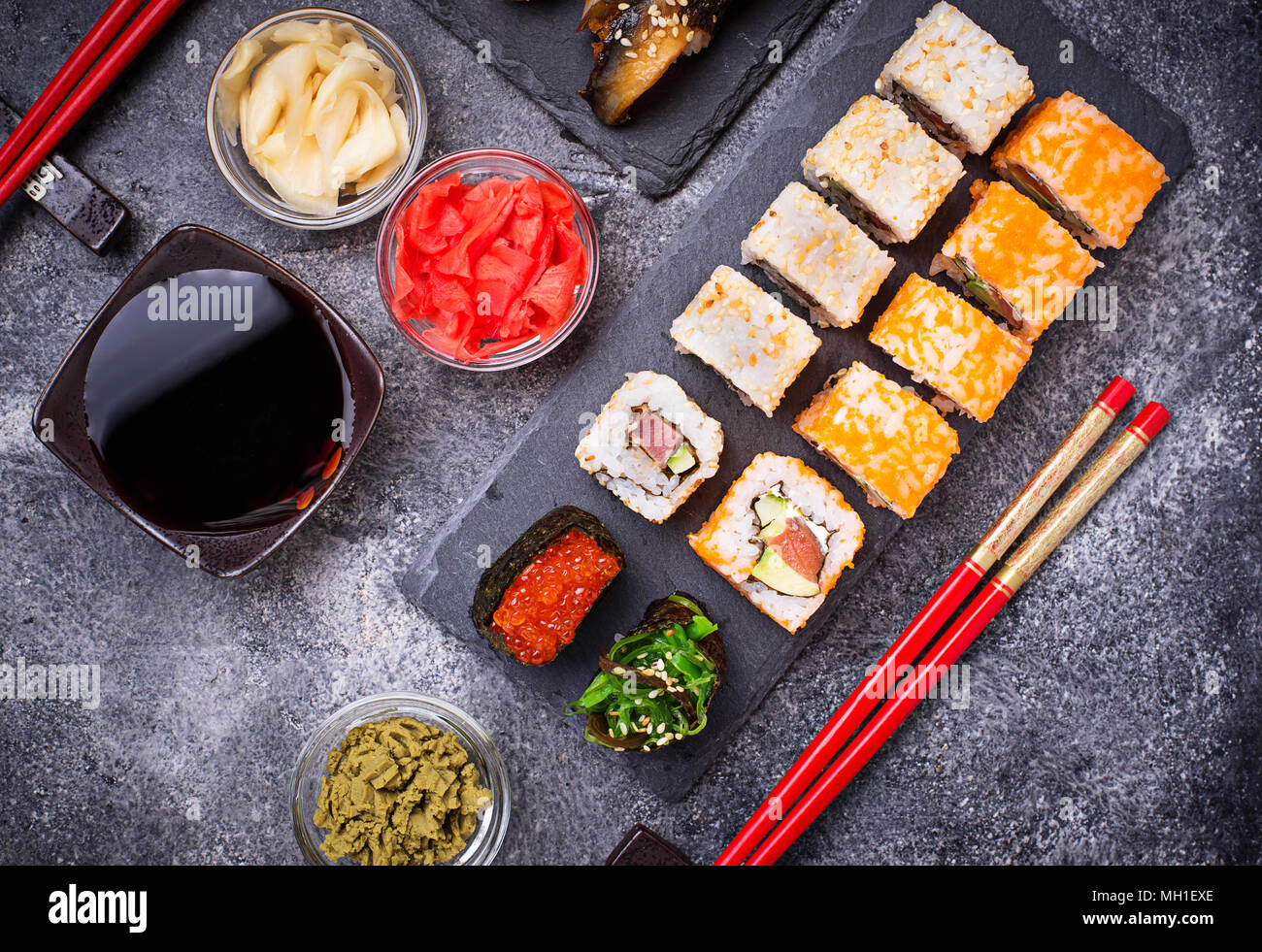 Sushi and roll set on black table. Top view Stock Photo - Alamy