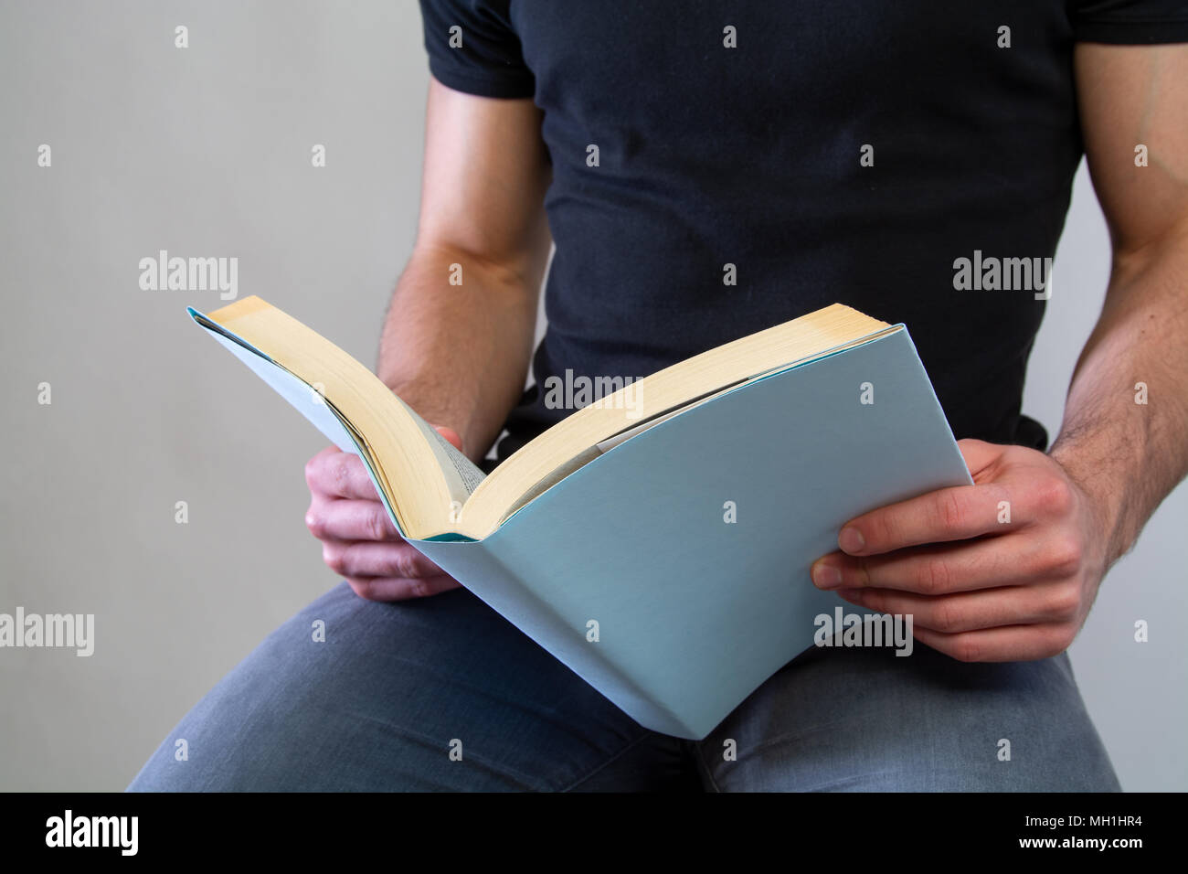 Absorbed man reading book sitting hi-res stock photography and images ...
