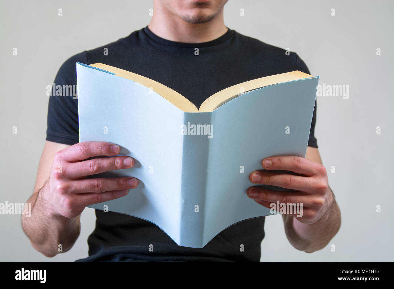 Absorbed man reading book sitting hi-res stock photography and images ...