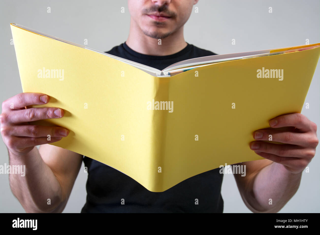 Absorbed man reading book sitting hi-res stock photography and images ...