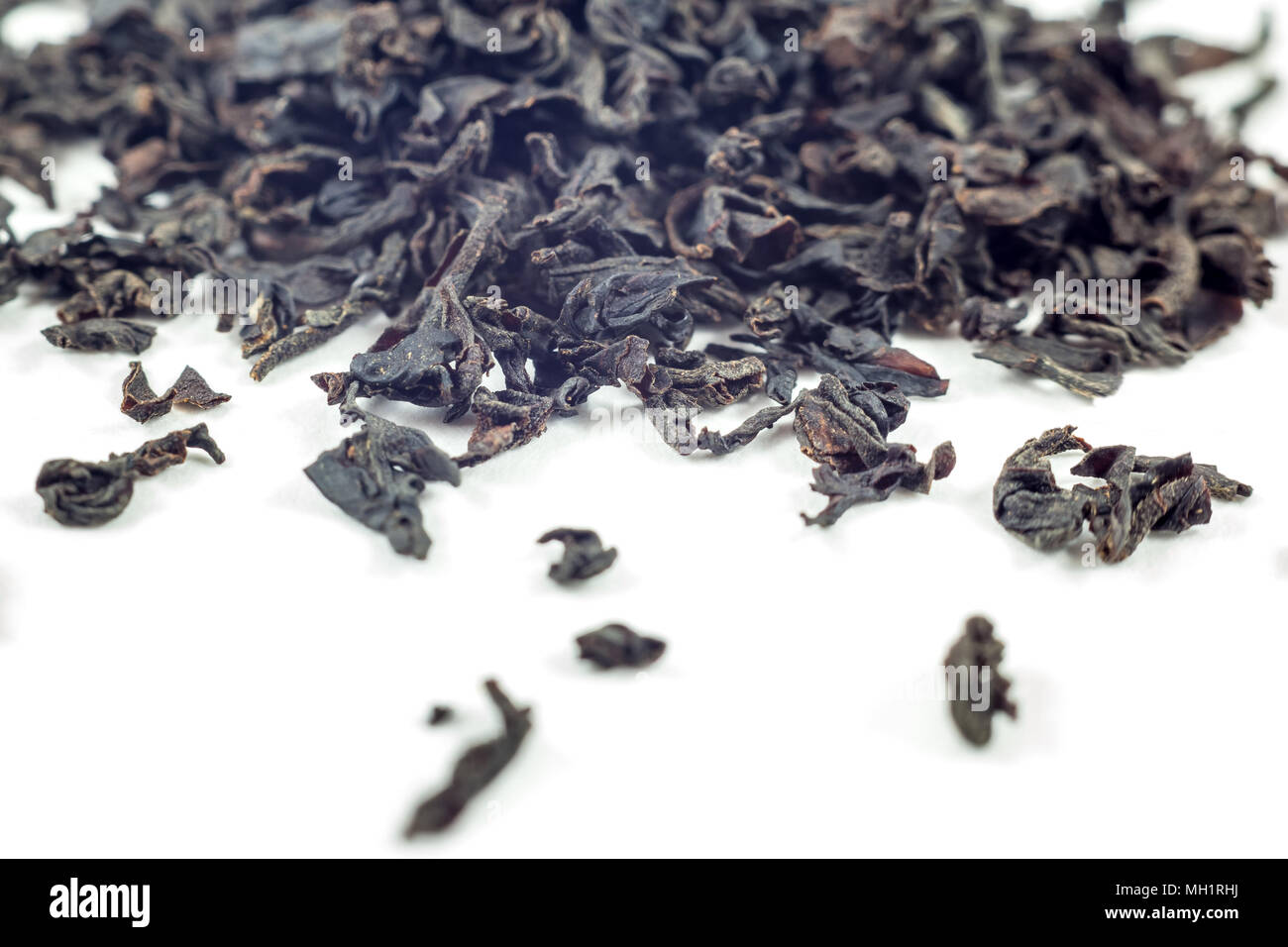Dry black tea leaves isolated on white background Stock Photo - Alamy