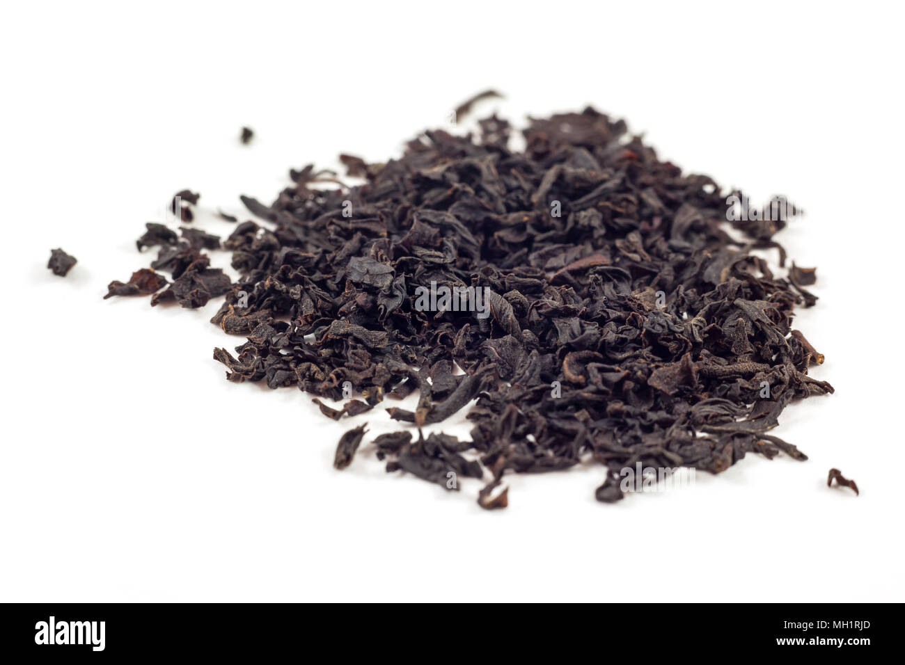 Dry black tea leaves isolated on white background Stock Photo - Alamy