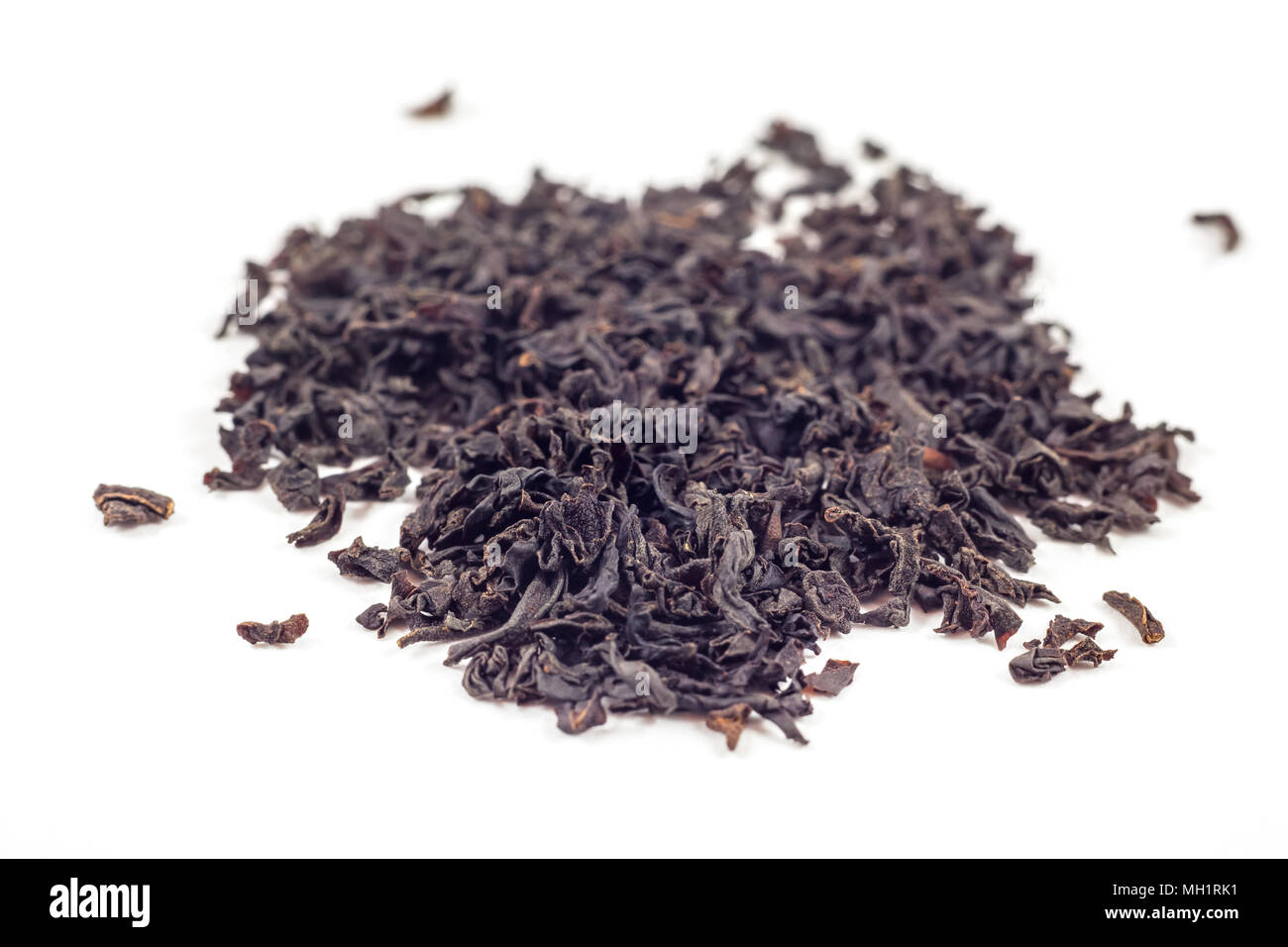 Dry black tea leaves isolated on white background Stock Photo - Alamy