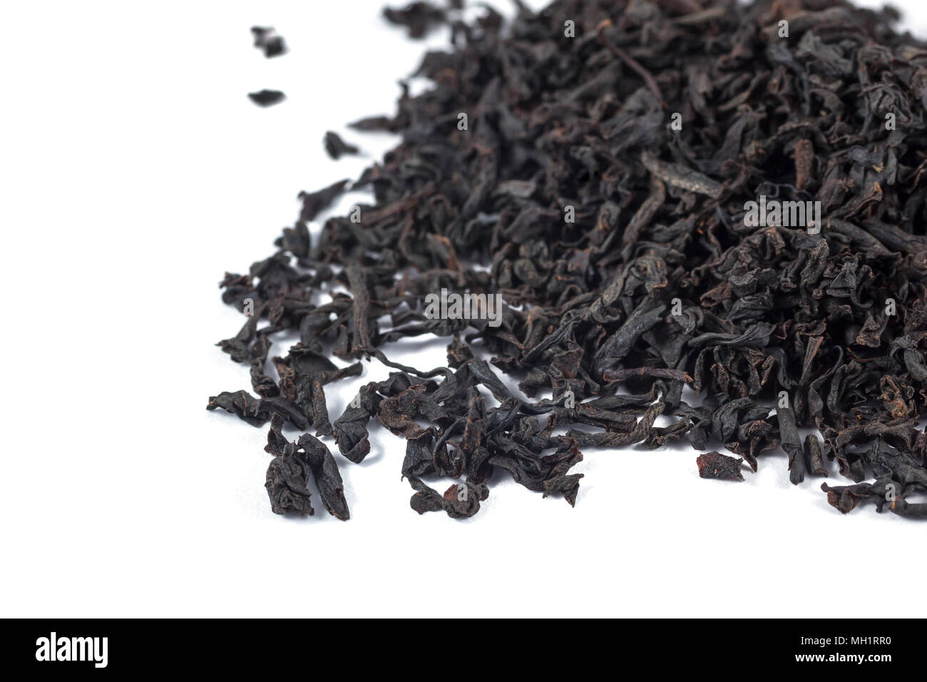 Dry black tea leaves isolated on white background Stock Photo - Alamy