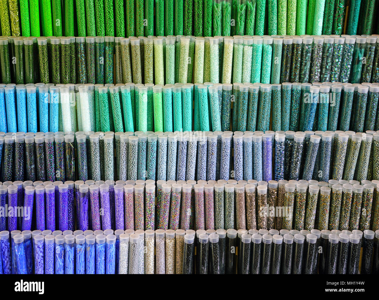 Display of tubes of colorful glass beads in an arts and craft store ...