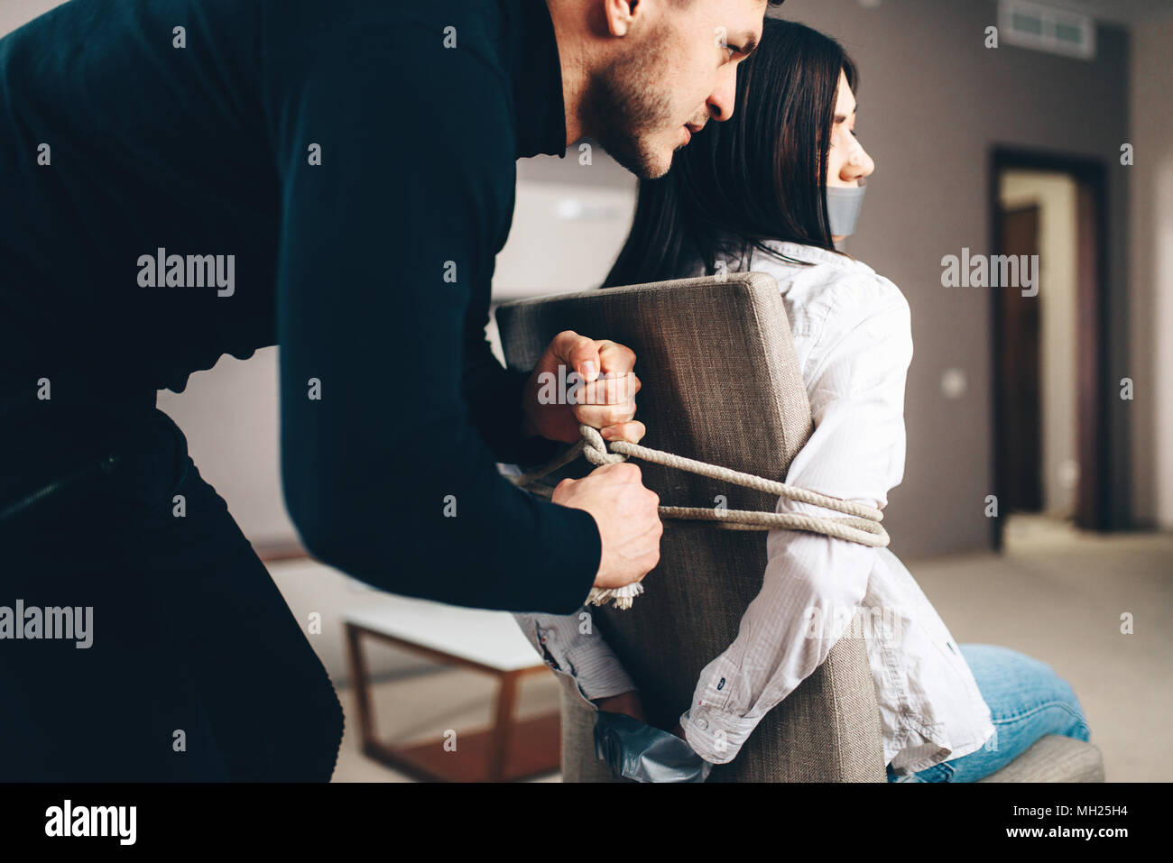Man tied to chair hi-res stock photography and images - Alamy