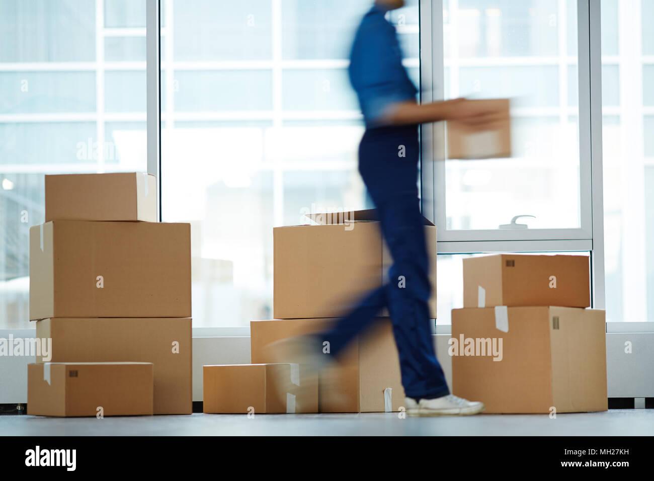 Man walking with boxes hi-res stock photography and images - Alamy