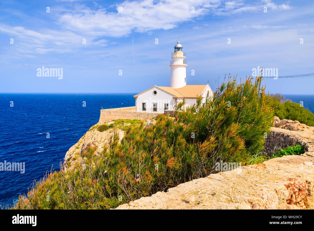 Lighthouse on high cliff above sea in Cala Ratjada, Majorca island ...