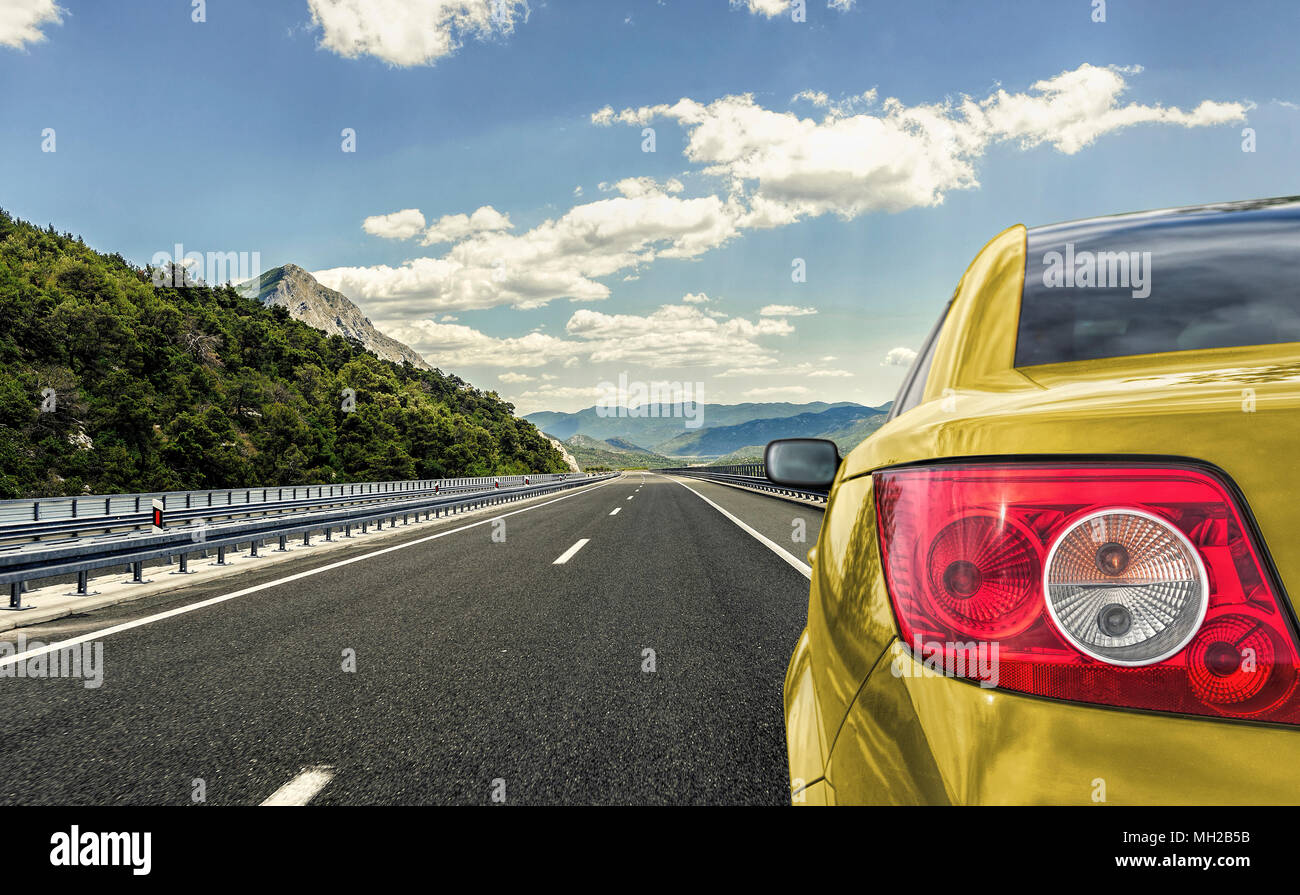 Yellow car rushing along a high-speed highway Stock Photo - Alamy