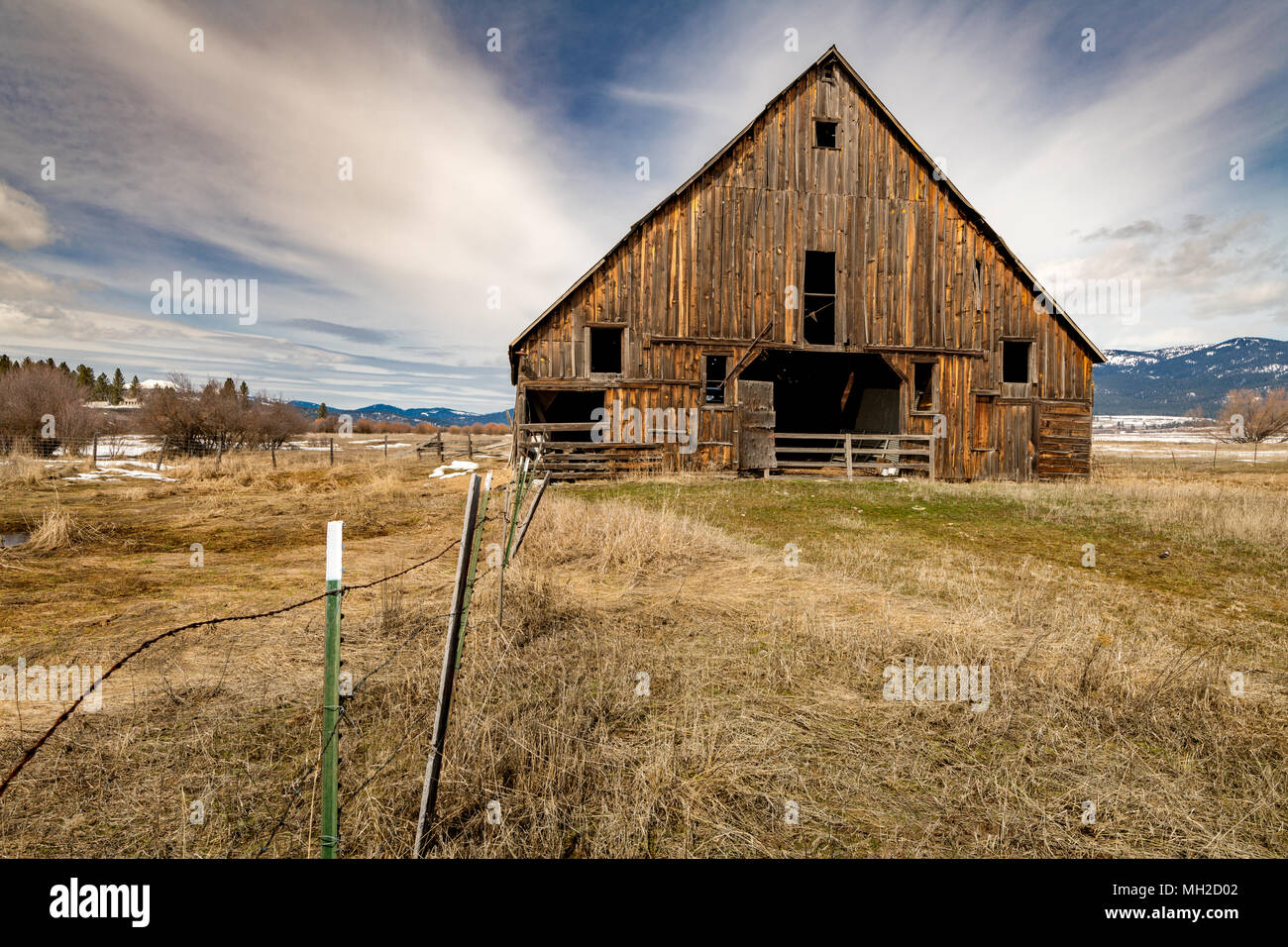 Classic old weather barn on an Idaho farm with unique sky and clouds ...