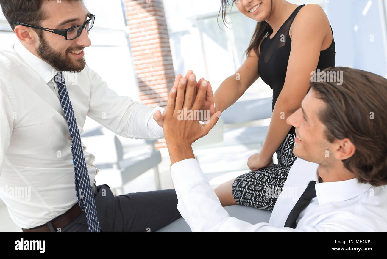 members of the business team give each other high five Stock Photo - Alamy
