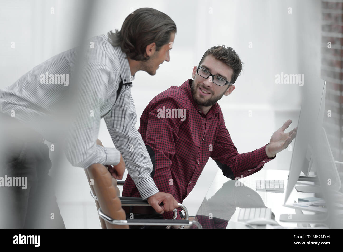 two office employee talking in the office Stock Photo - Alamy