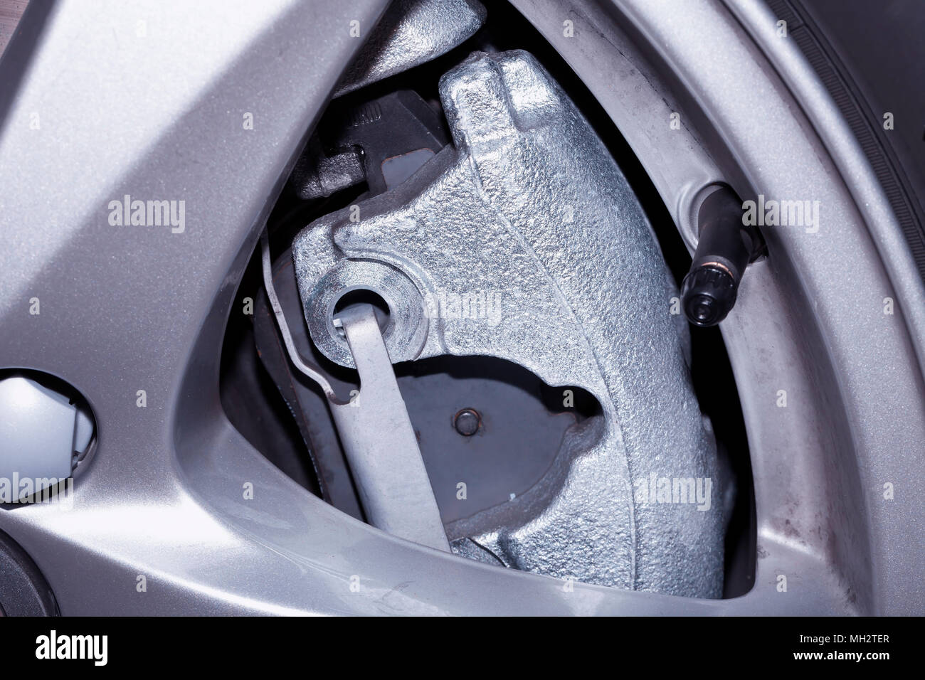 The aluminum wheel of a modern car where you can see the disc brake ...