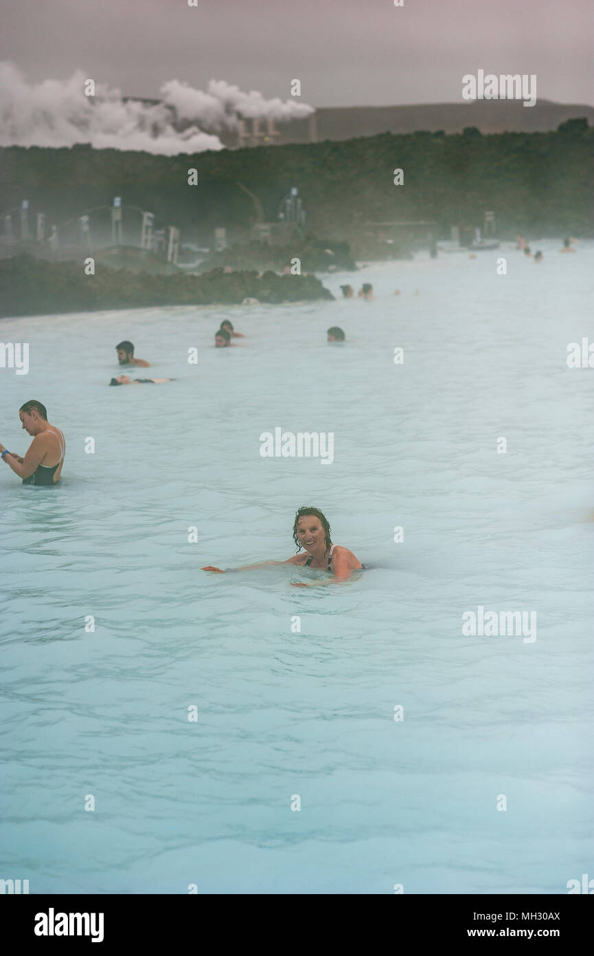 Tourists and visitors enjoy outdoor geothermal swimming pool at the ...