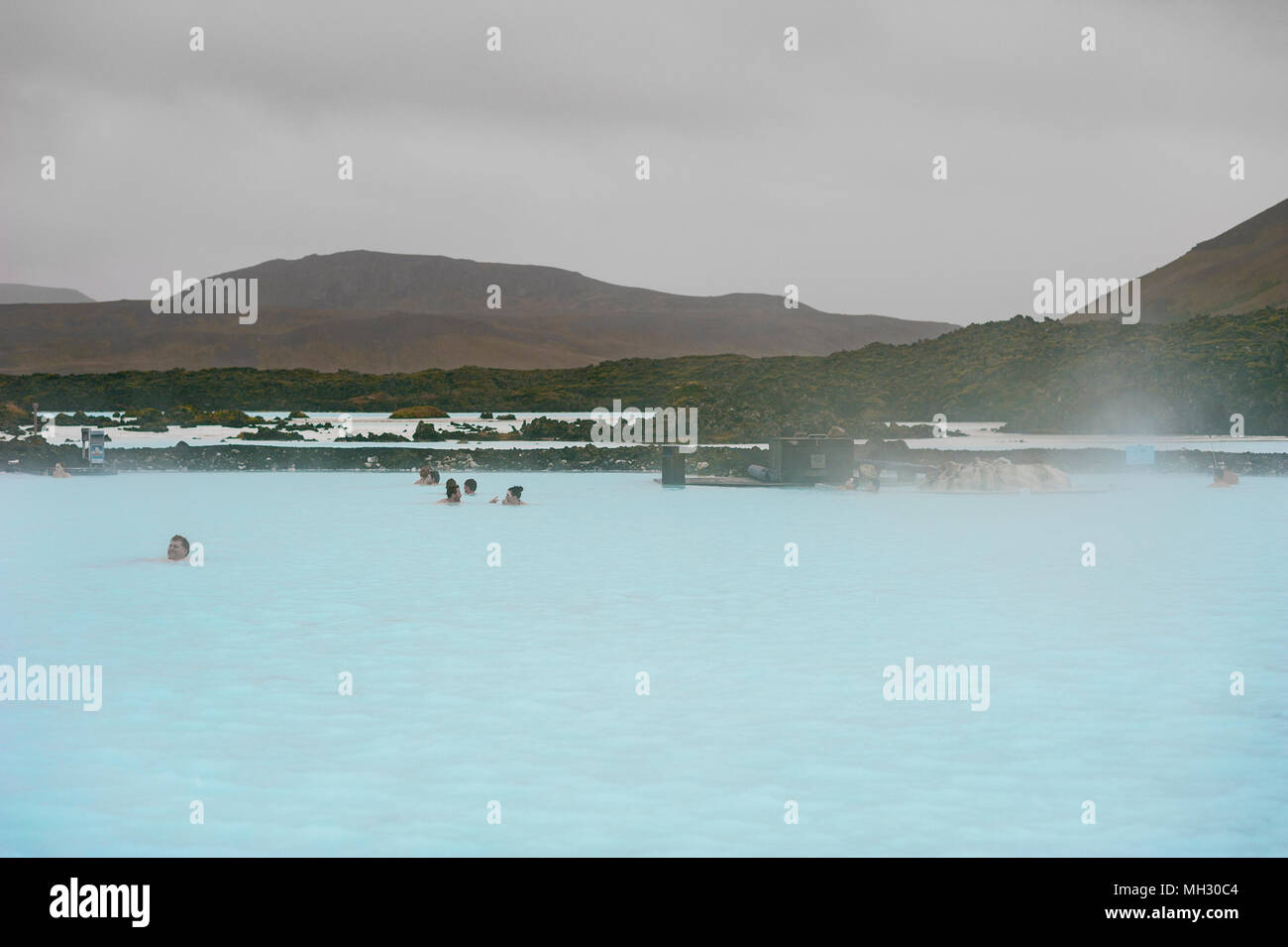 Tourists and visitors enjoy outdoor geothermal swimming pool at the ...
