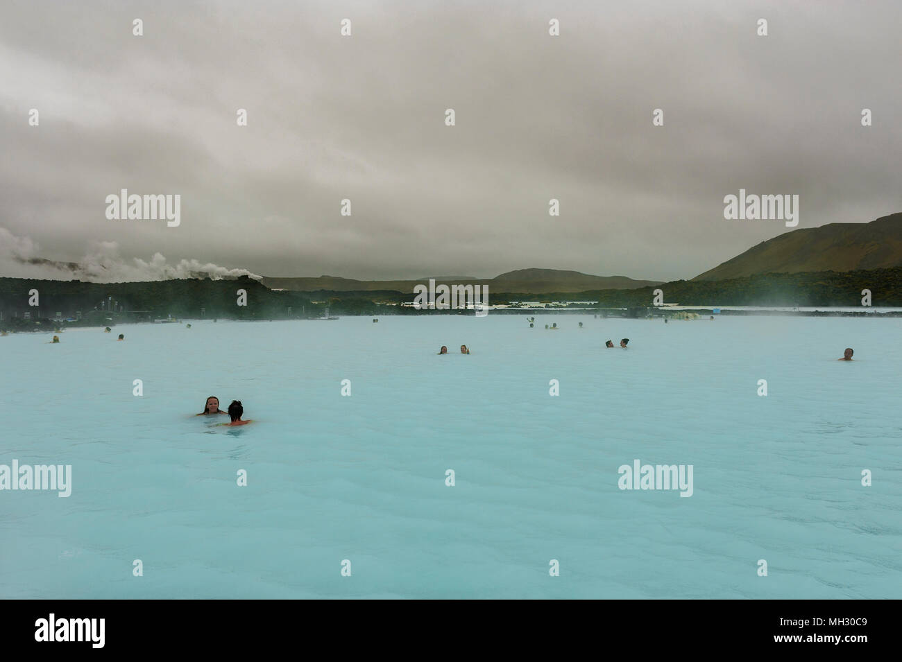 Tourists and visitors enjoy outdoor geothermal swimming pool at the ...