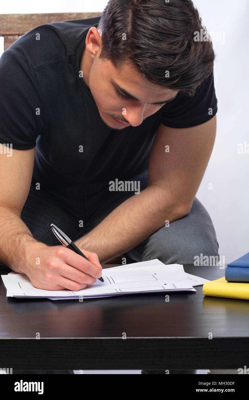 a young man with black tshirt writing in a story board cheat Stock ...