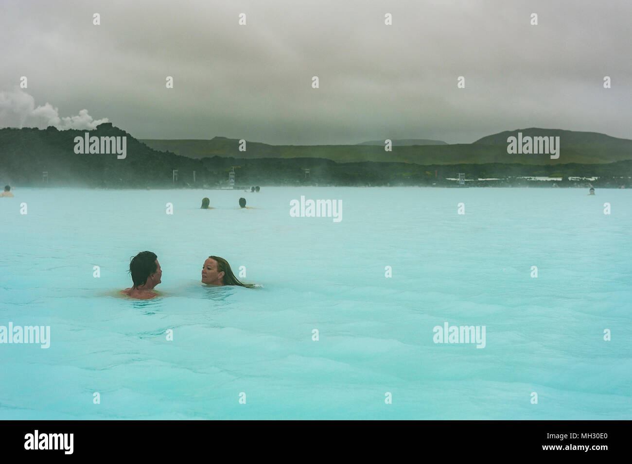 Tourists and visitors enjoy outdoor geothermal swimming pool at the ...