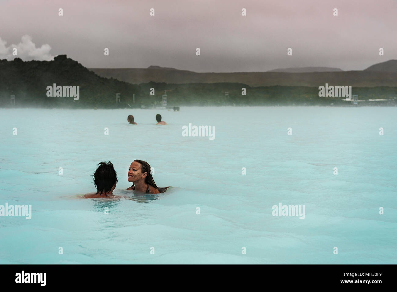 Tourists and visitors enjoy outdoor geothermal swimming pool at the ...