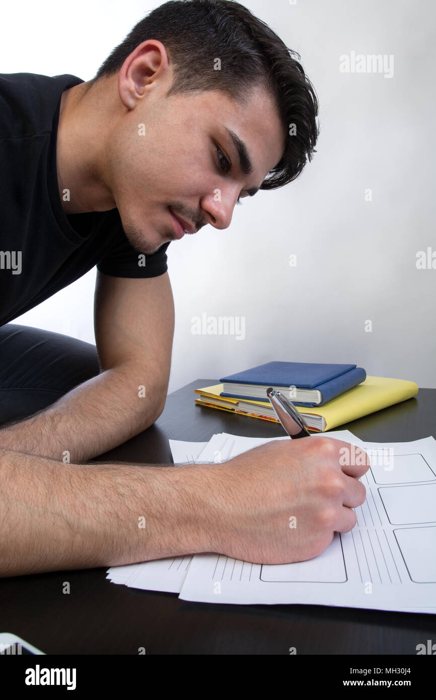 a young man with black tshirt writing in a story board cheat Stock ...