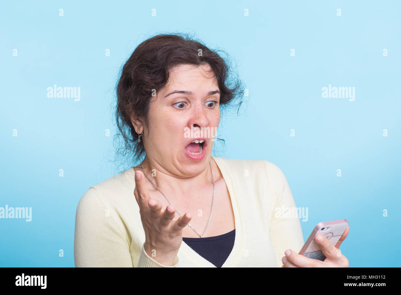 Angry aggressive woman on blue background Stock Photo - Alamy