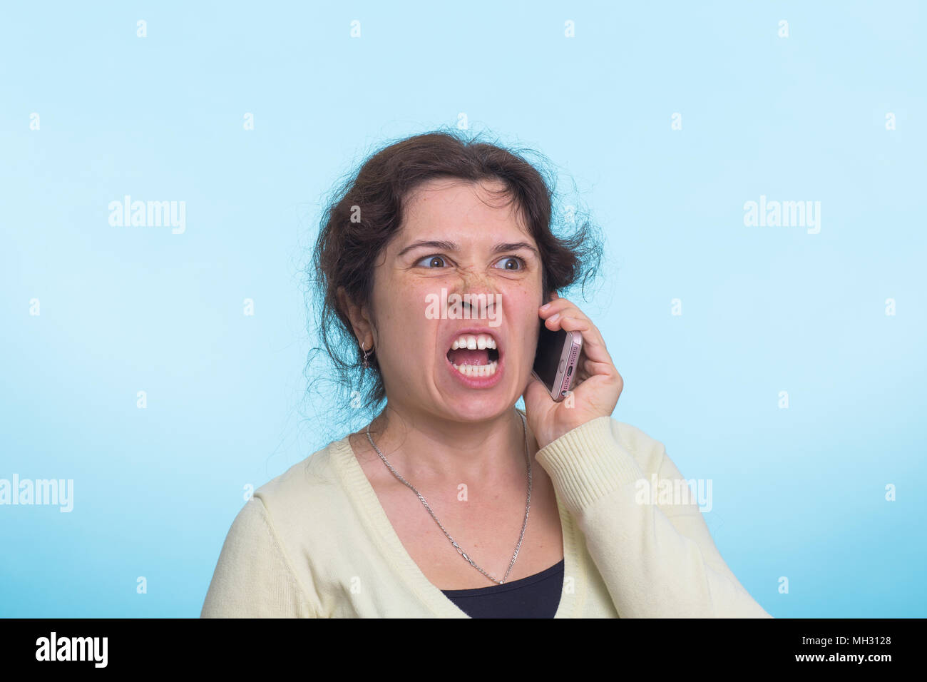 Angry aggressive woman screams on cell phone Stock Photo - Alamy