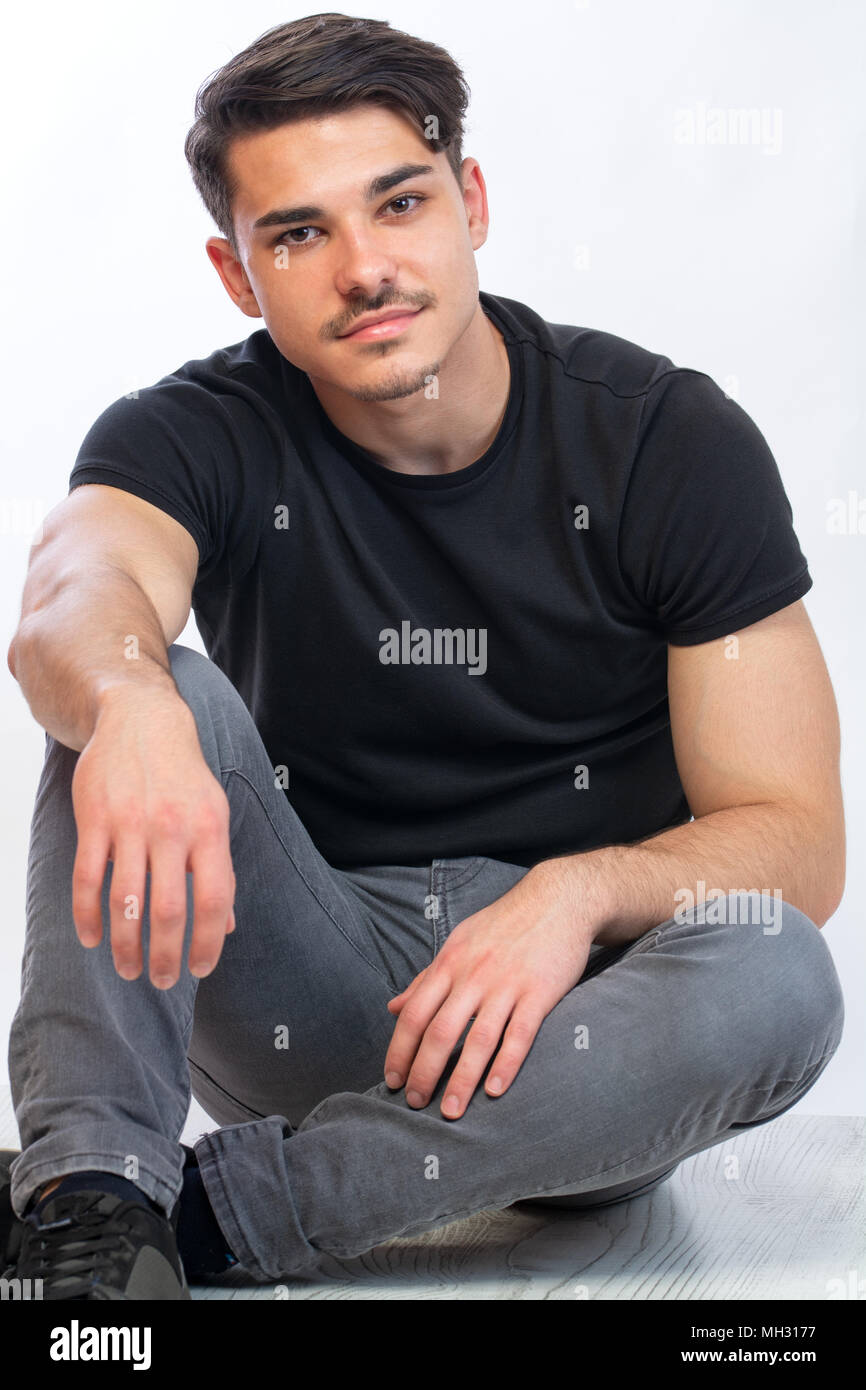 a young man with black tshirt agaist white background Stock Photo - Alamy