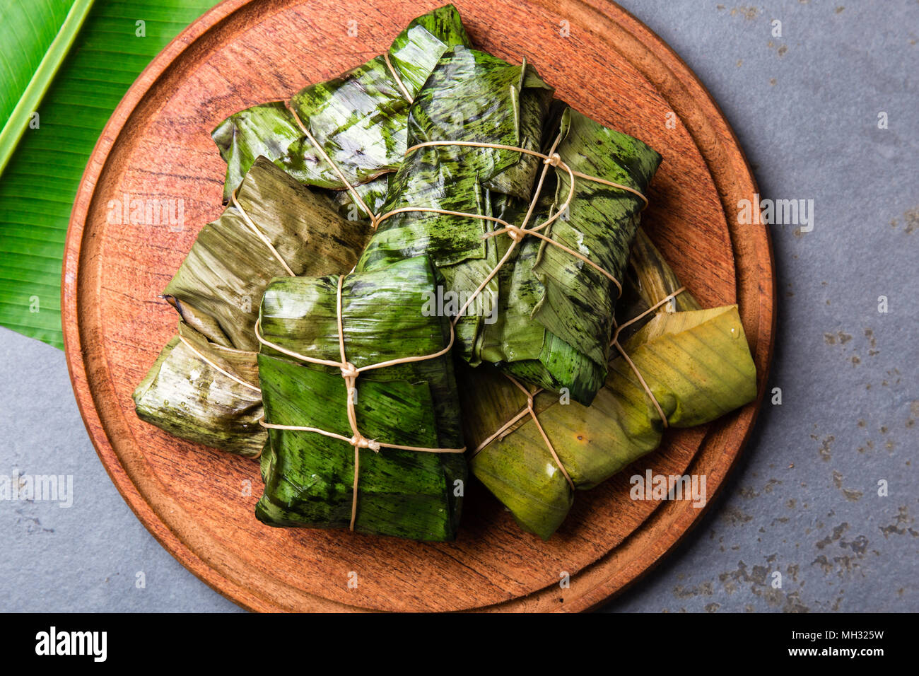 COLOMBIAN, CENTRAL AMERICAN FOOD. Tamales wrapped in banana palm tree ...