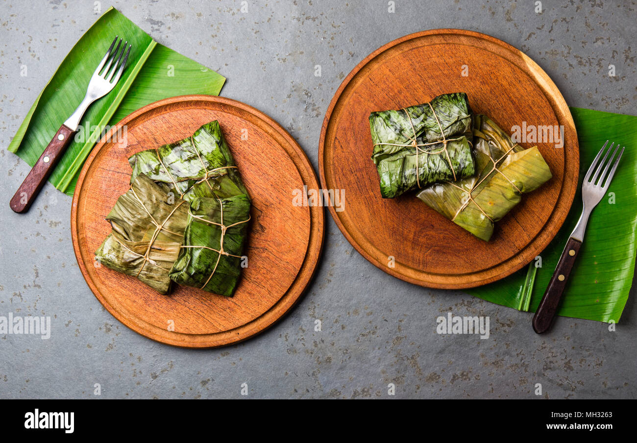 COLOMBIAN, CENTRAL AMERICAN FOOD. Tamales wrapped in banana palm tree ...