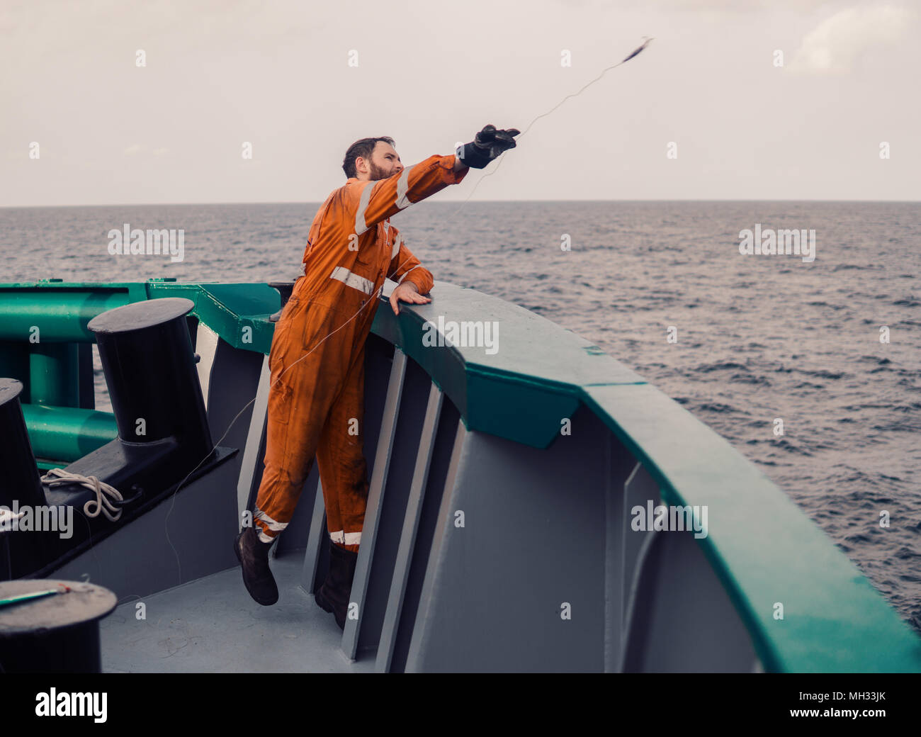 The fisherman throws a hook on a ship for catching tuna fish. Fishing ...