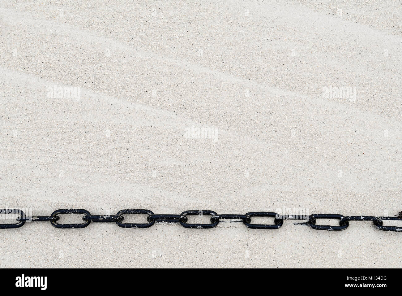 stretched black chain on windswept beach sand Stock Photo - Alamy