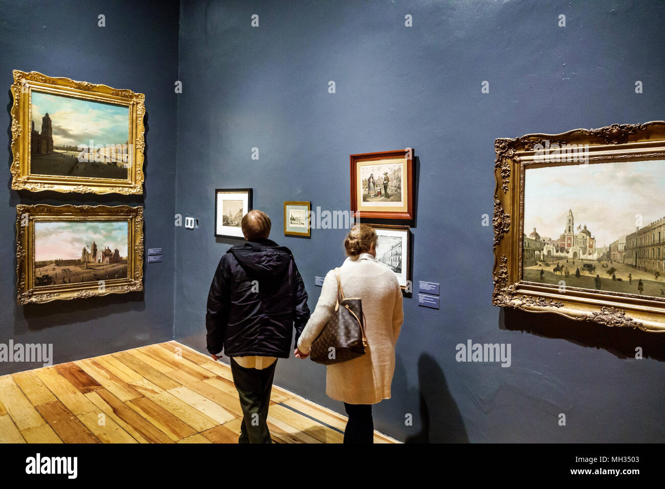 Visitors looking paintings in exhibition hi-res stock photography and ...